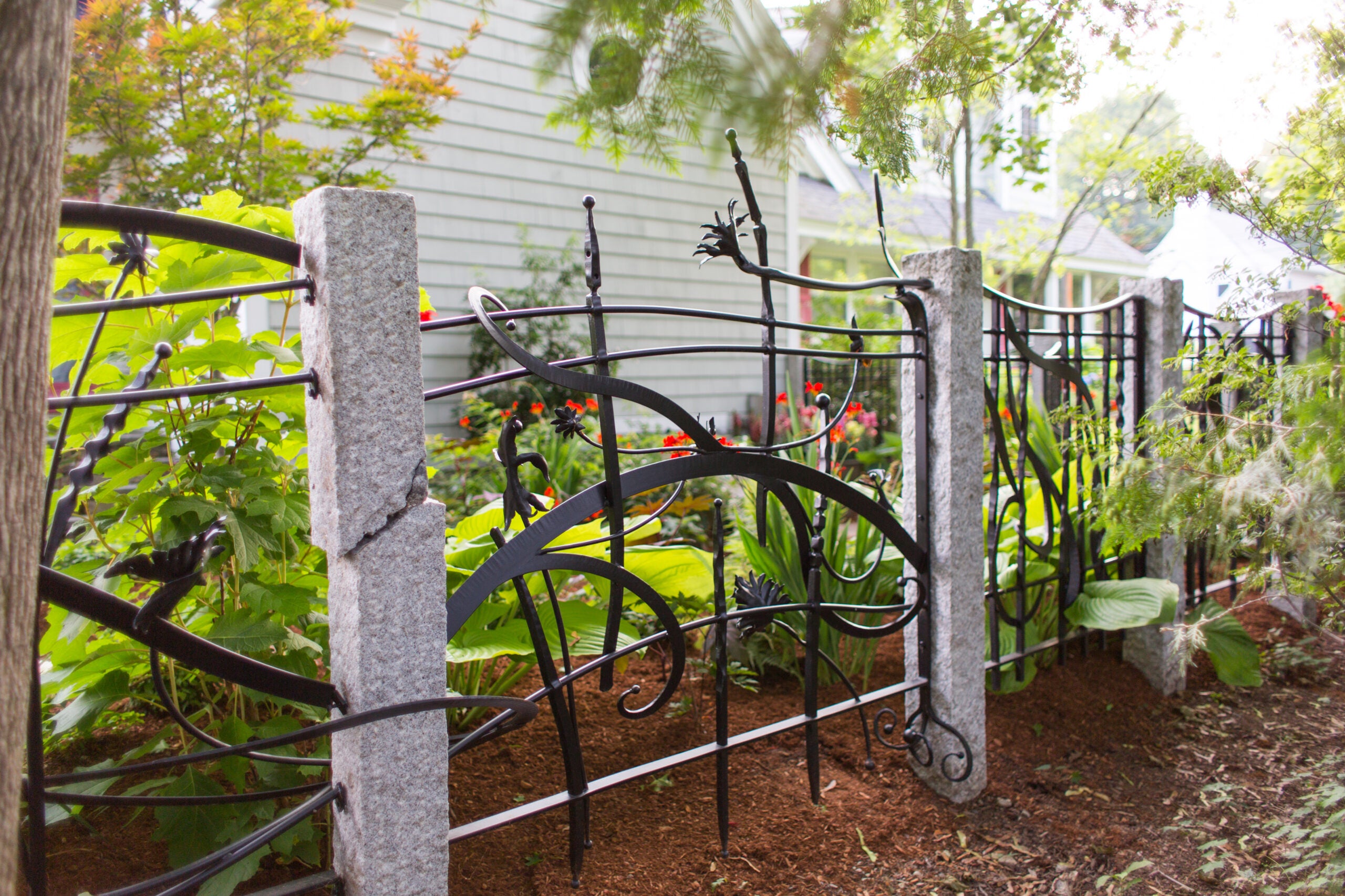 How an iron fence defines the garden at a famous novelist's Concord home