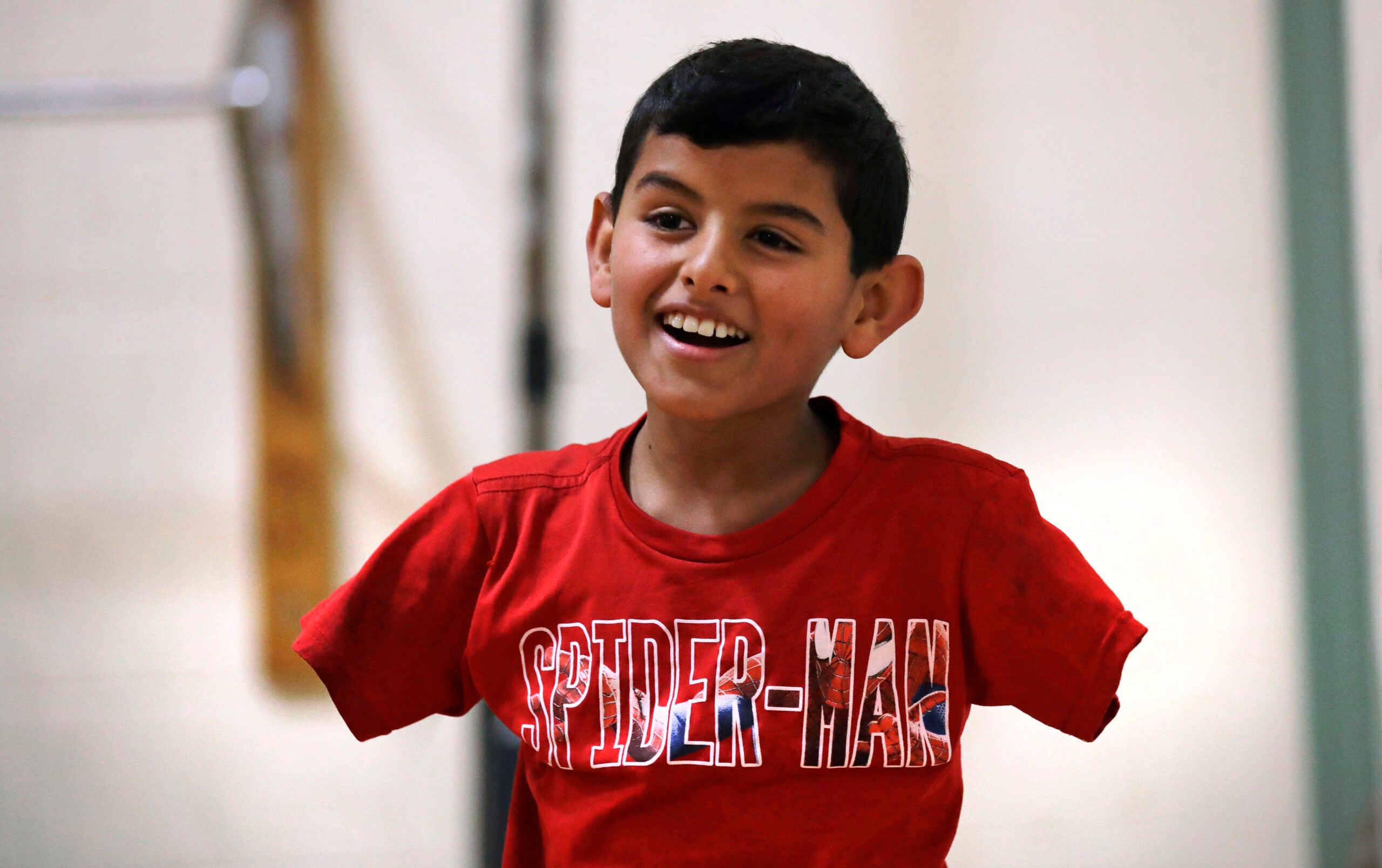 Armless Syrian boy thrives in Massachusetts, hopes family can join him