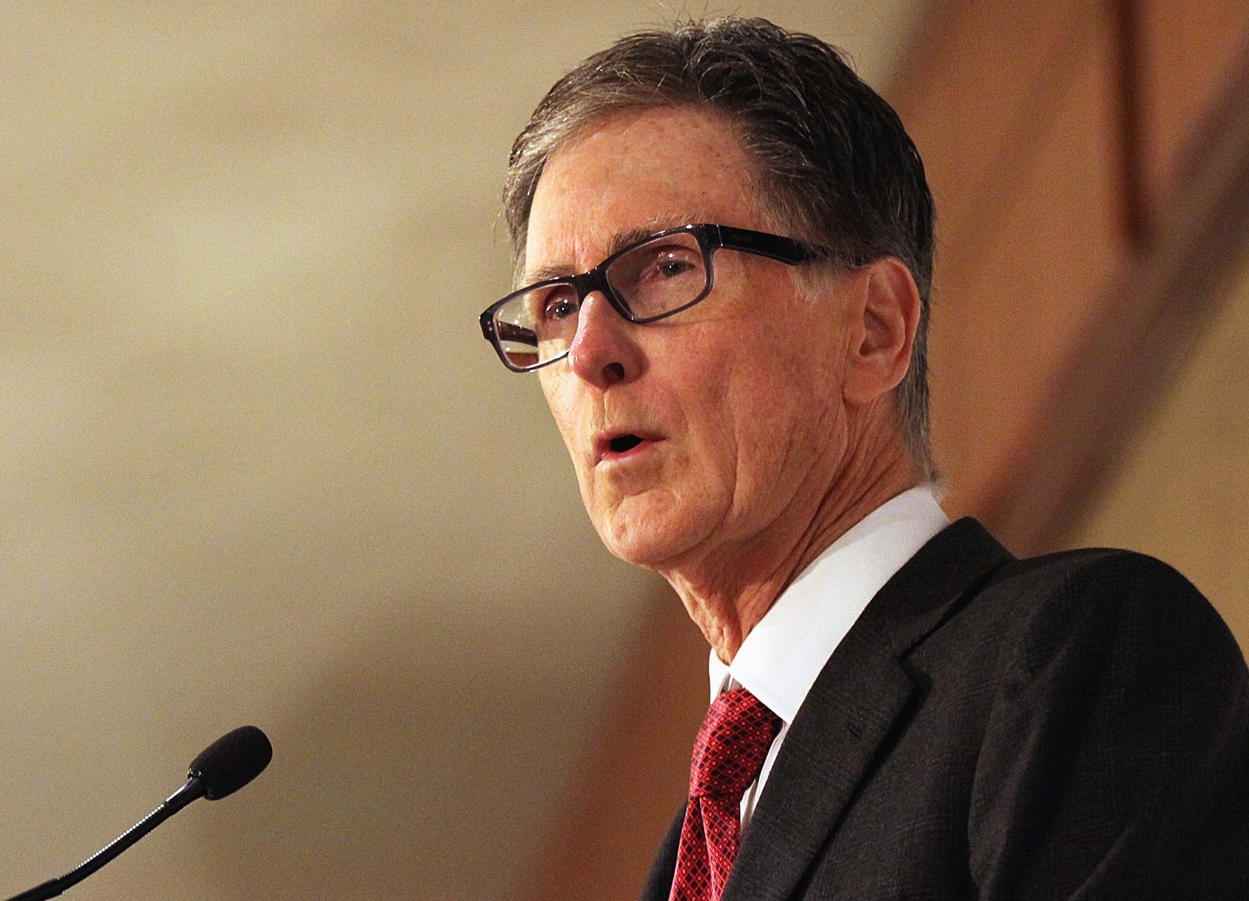 John Henry stands behind Jerry Remy