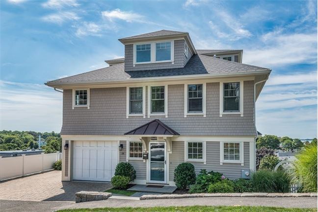 This open Colonial-style home boasts views of Swampscott Harbor