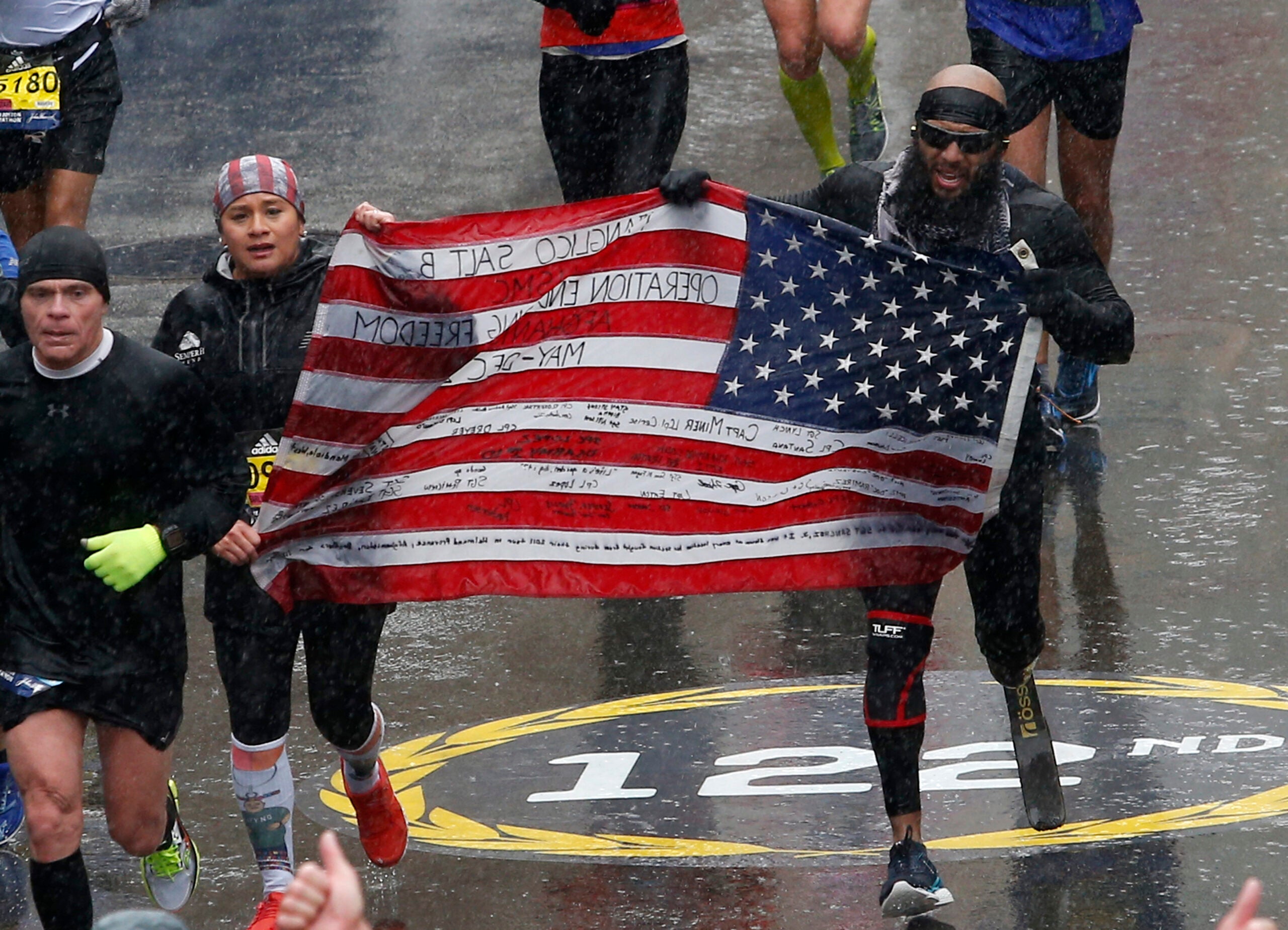 This Marine hoisting an American flag just finished his third straight ...