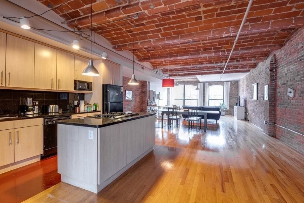 For $1.3M, Leather District loft with rolling brick ceilings