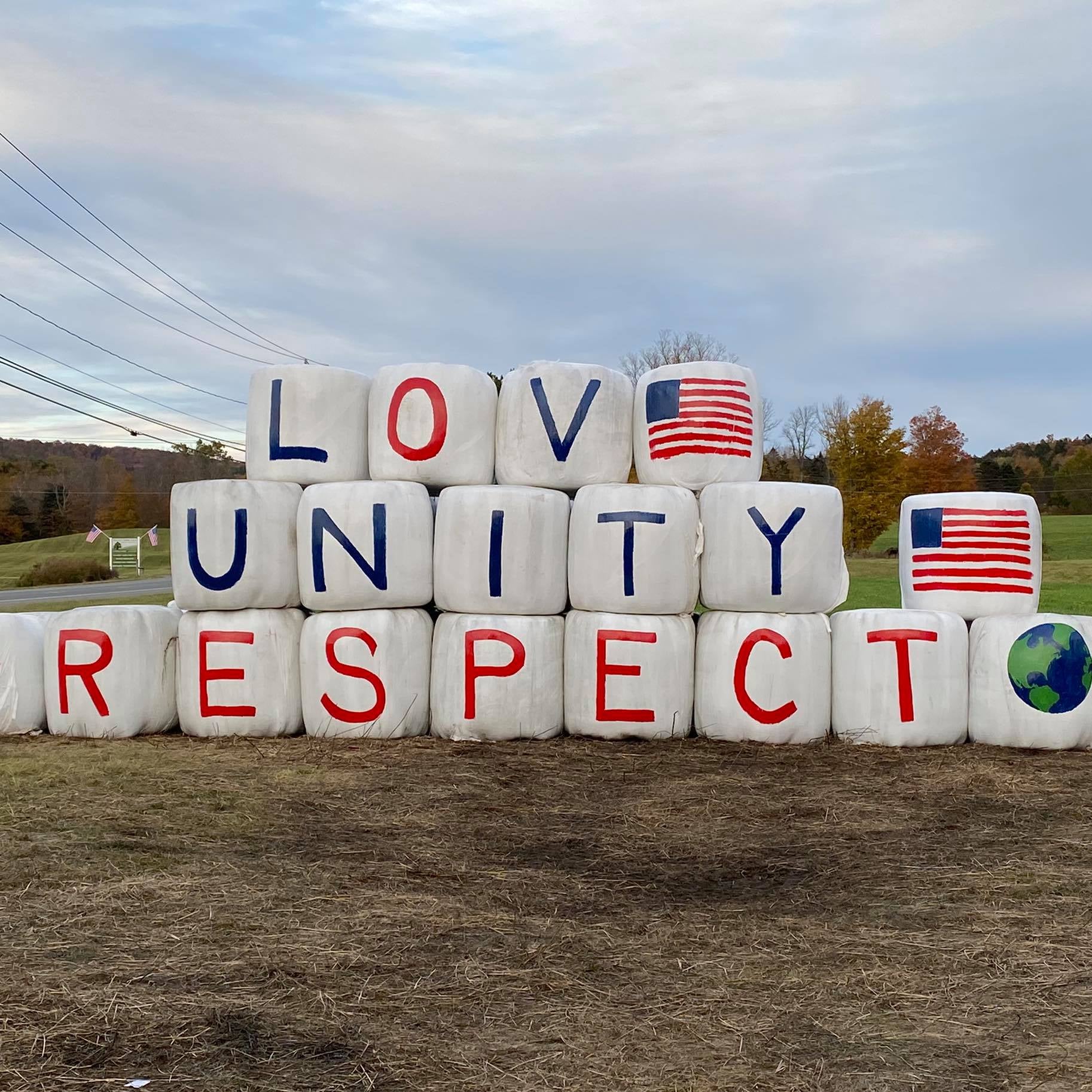 Farm rebuilds hay bale sign after original was set on fire