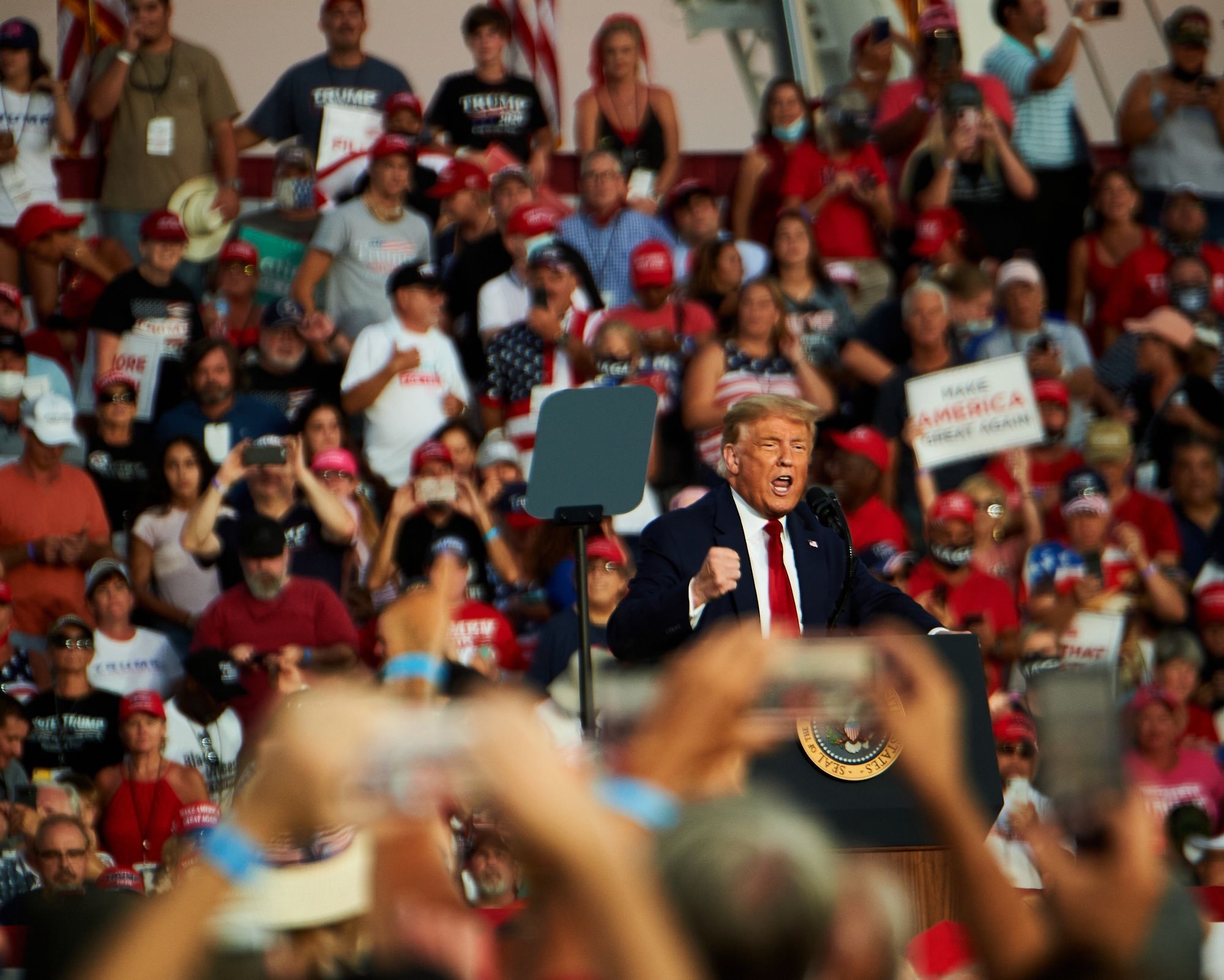 Defiant Trump defends virus record in 1st post-COVID rally