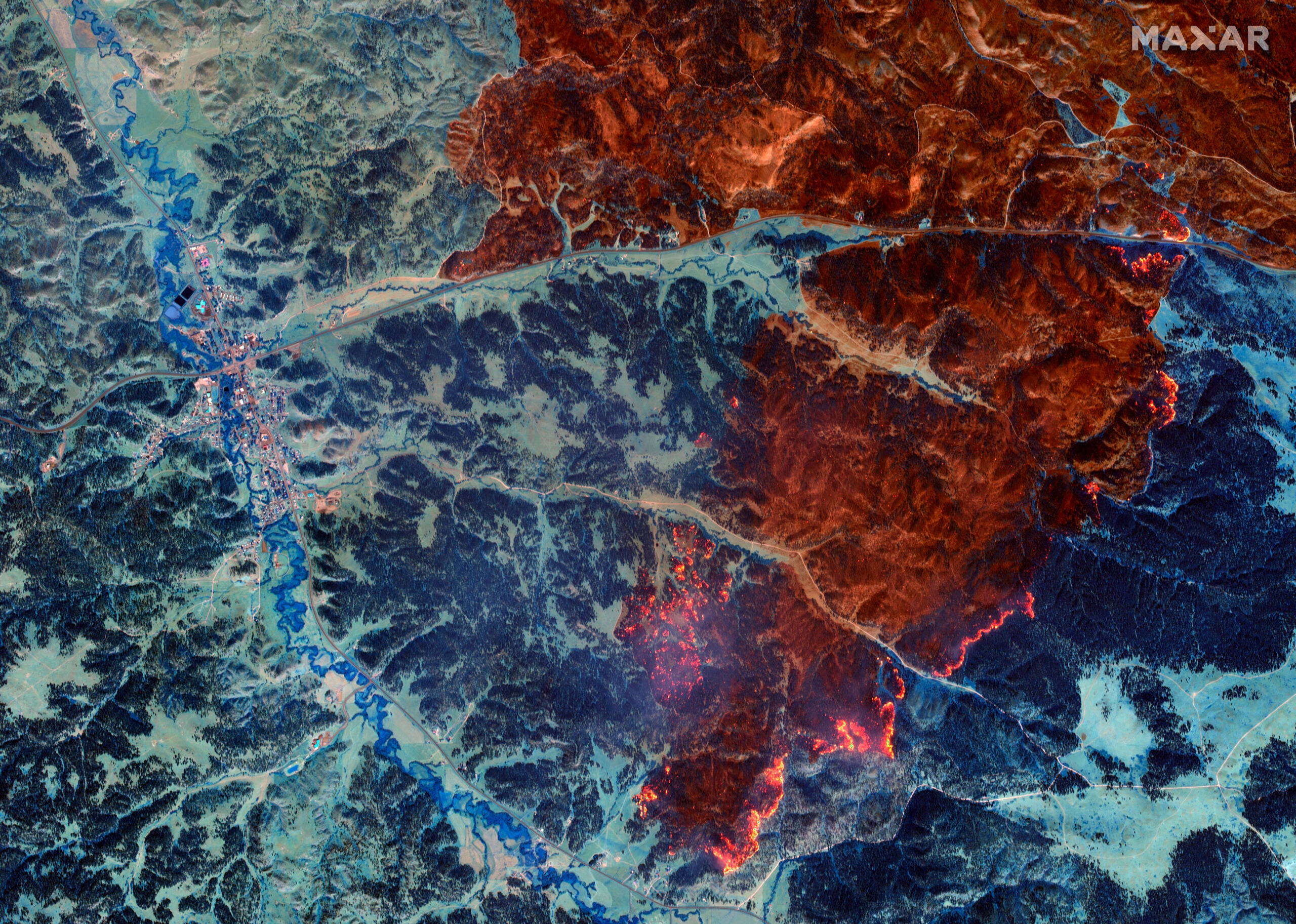 Western fires threaten thousands of homes, strain resources