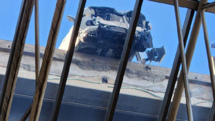 Car crashes, hangs over edge of parking garage