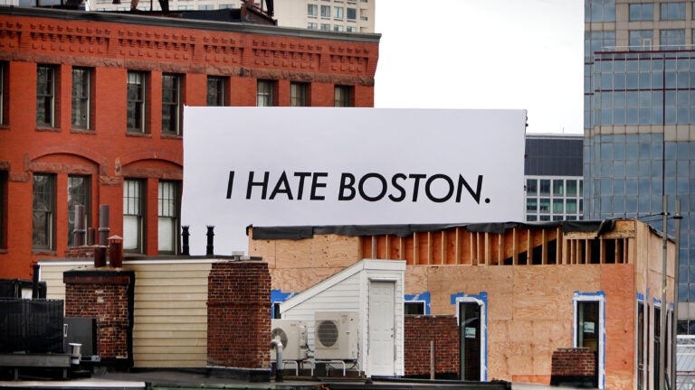 Why is there an 'I Hate Boston' billboard in the North End?