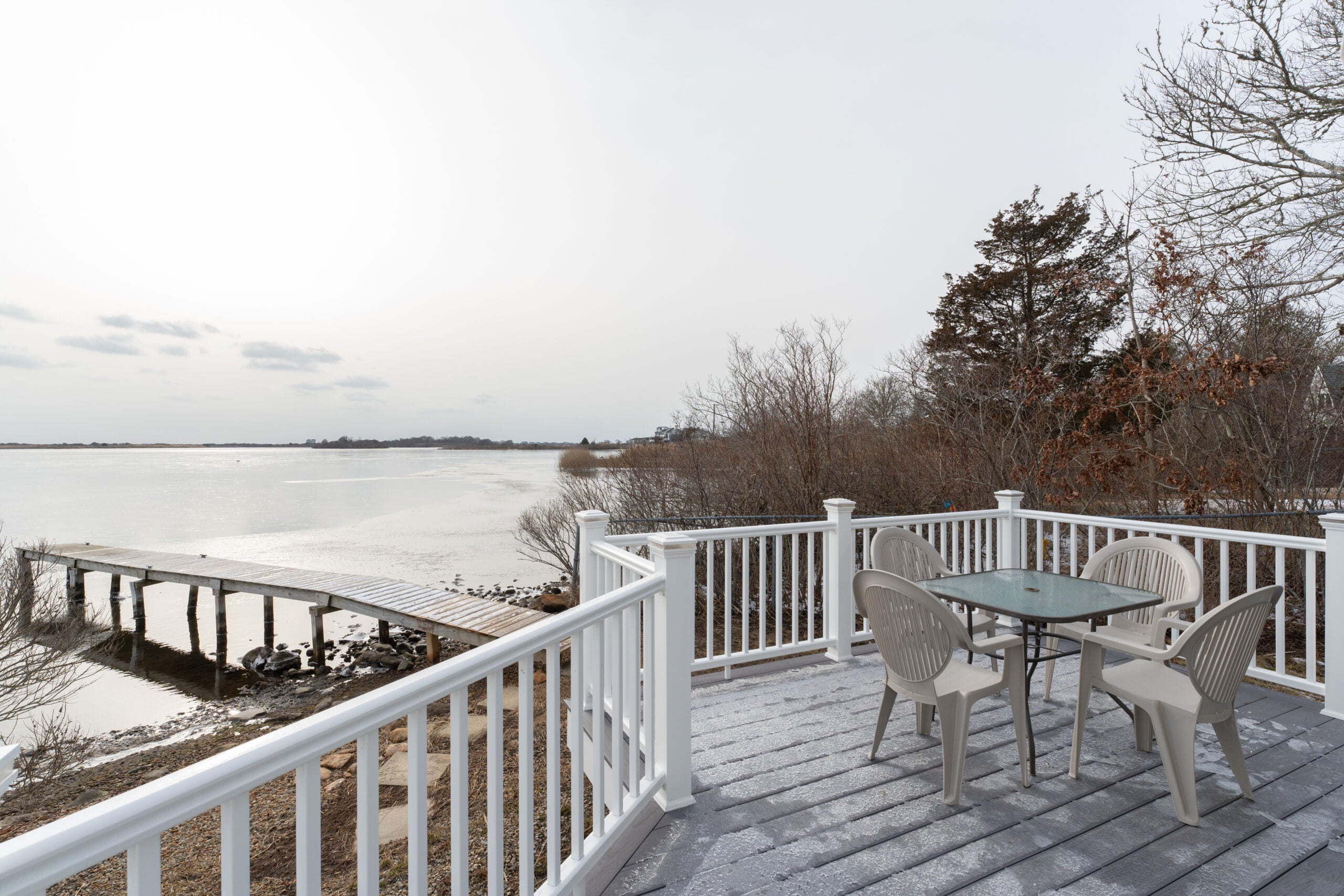 In Rhode Island, a pondside cottage with a private dock. See inside.