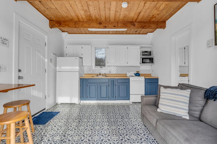 In Rhode Island, a pondside cottage with a private dock. See inside.