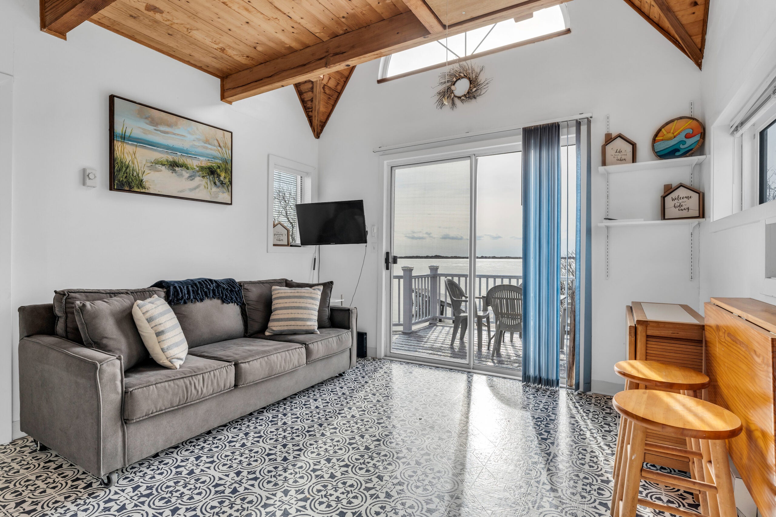 In Rhode Island, a pondside cottage with a private dock. See inside.