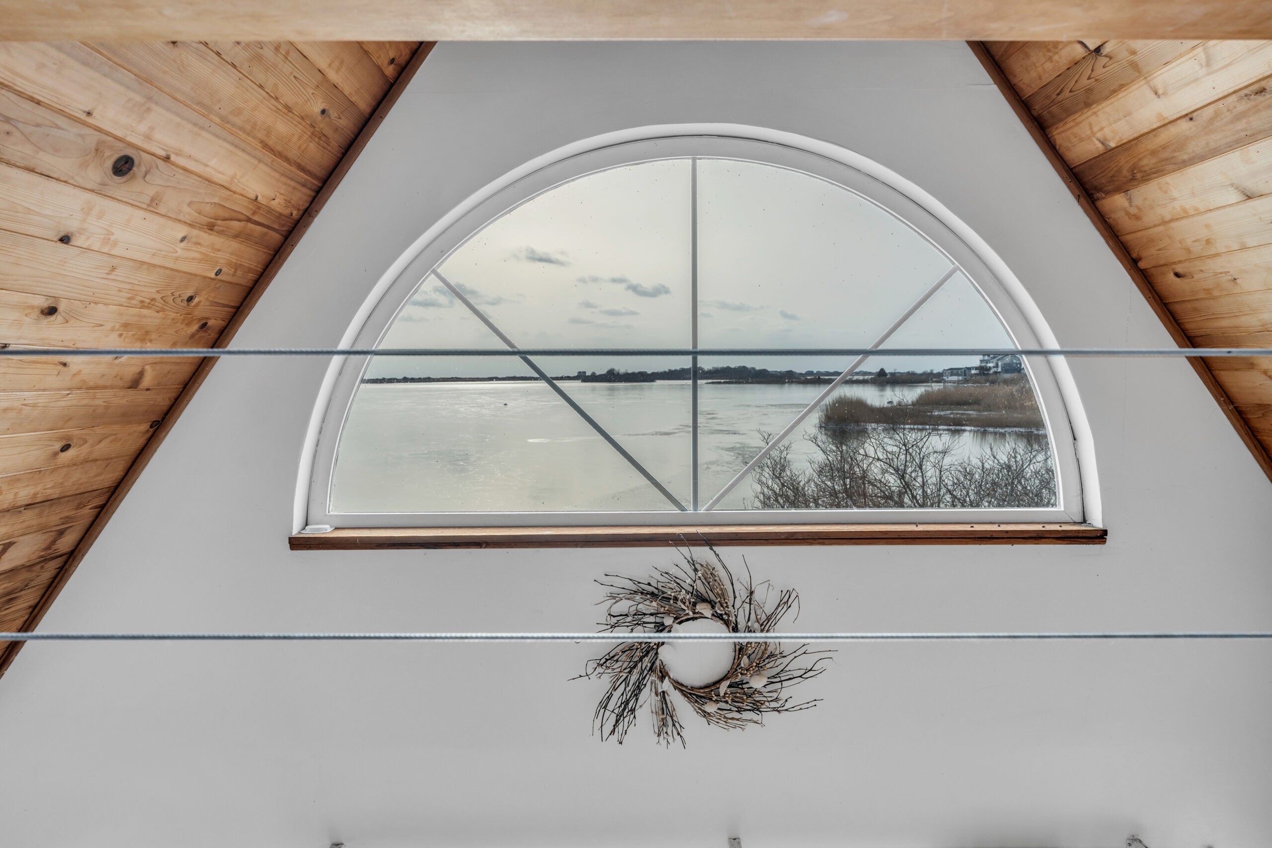 In Rhode Island, a pondside cottage with a private dock. See inside.